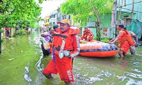 Chennai inundated Volunteers wade through flooded areas to distribute ...
